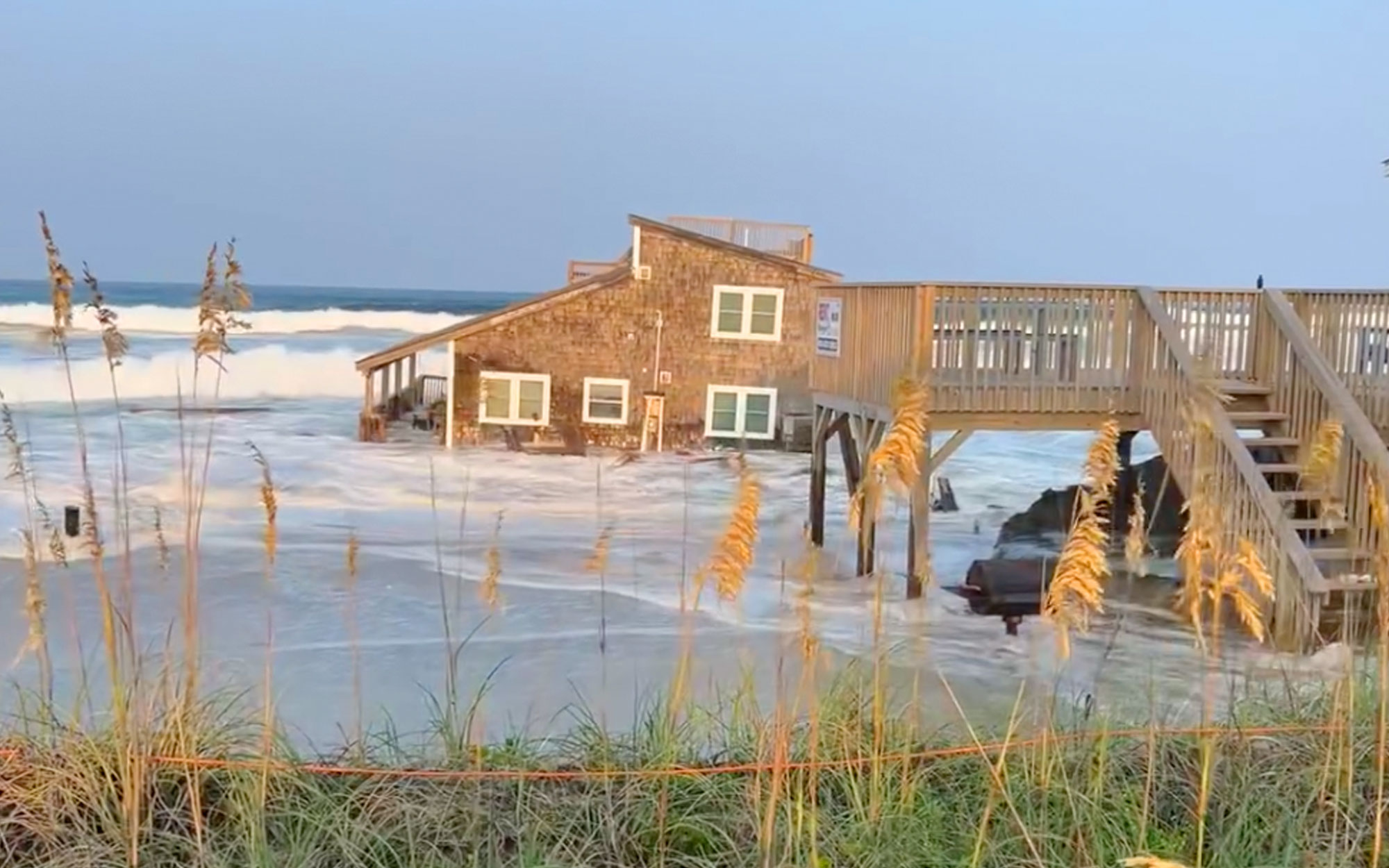 Wild video shows moment collapsed house is swept out to sea as ...